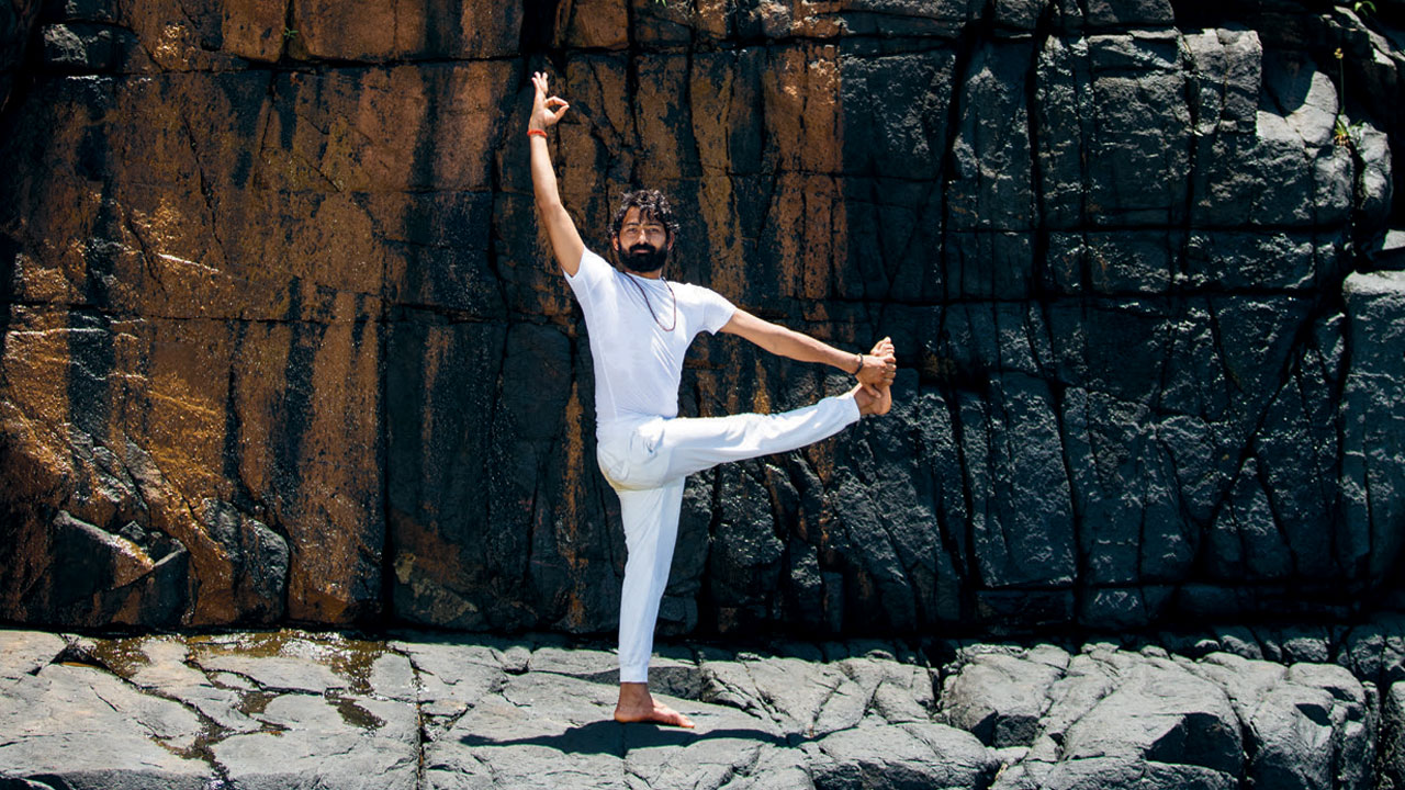 Revolved Extended Hand to Foot Pose | Om Yoga Magazine